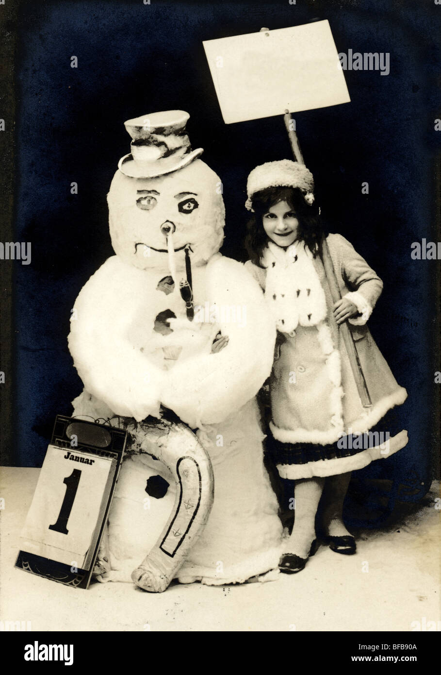 Little Girl with Fake Good Luck Snowman Stock Photo - Alamy