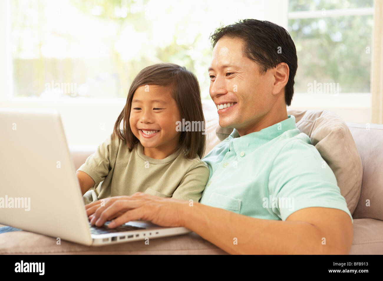 Father And Son Using Laptop At Home Stock Photo - Alamy