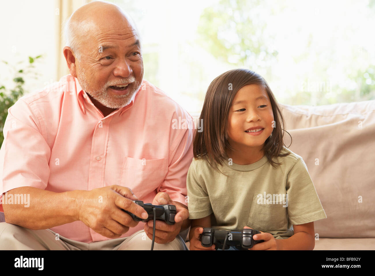 Grandfather And Granddaughter Playing Computer Game At Home Stock Photo ...