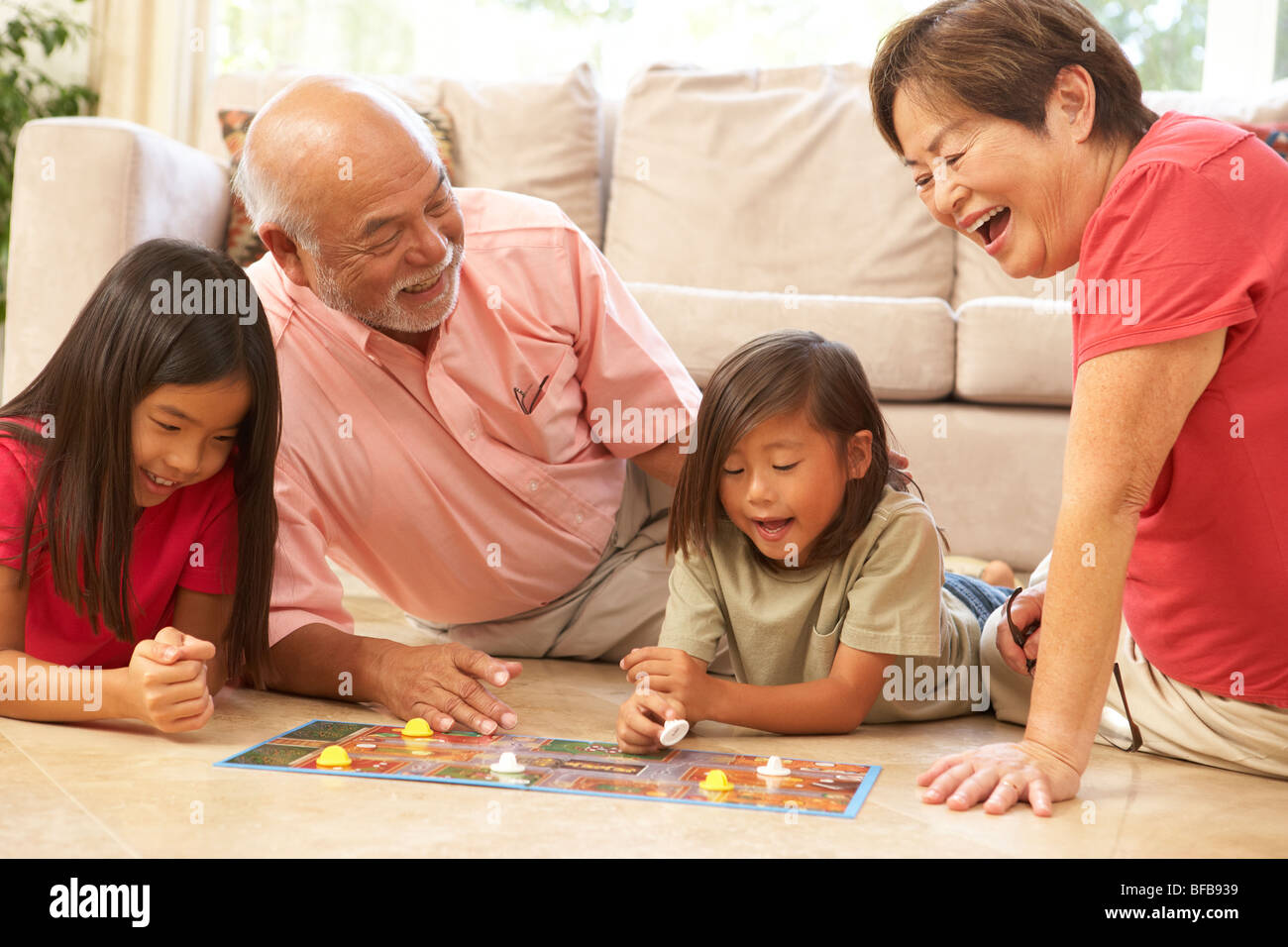 Grandparents And Grandchildren Playing Board Game At Home Stock Photo ...