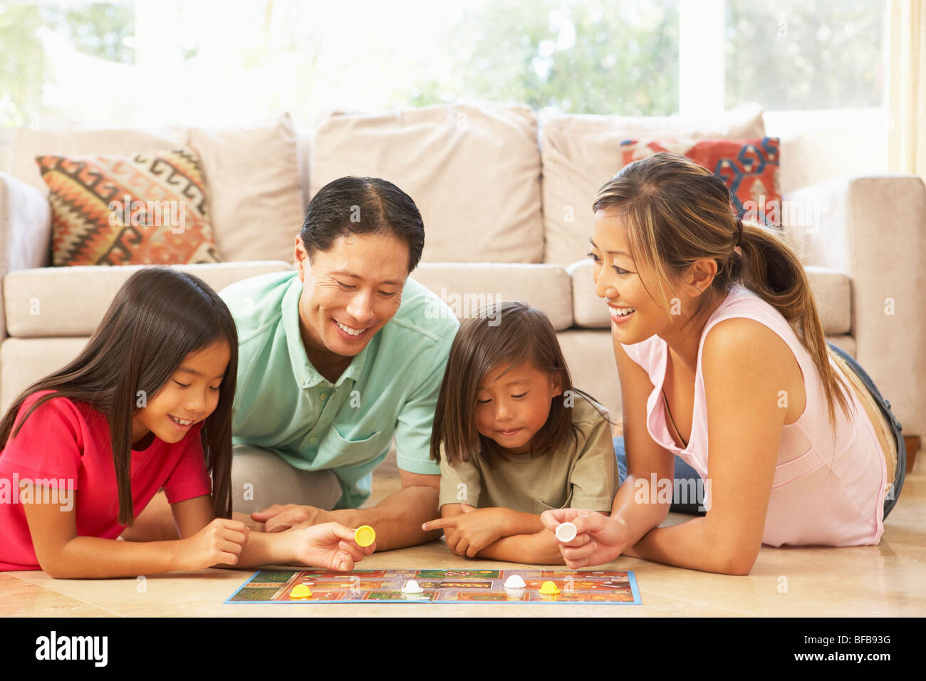 Family Playing Board Game At Home Stock Photo - Alamy