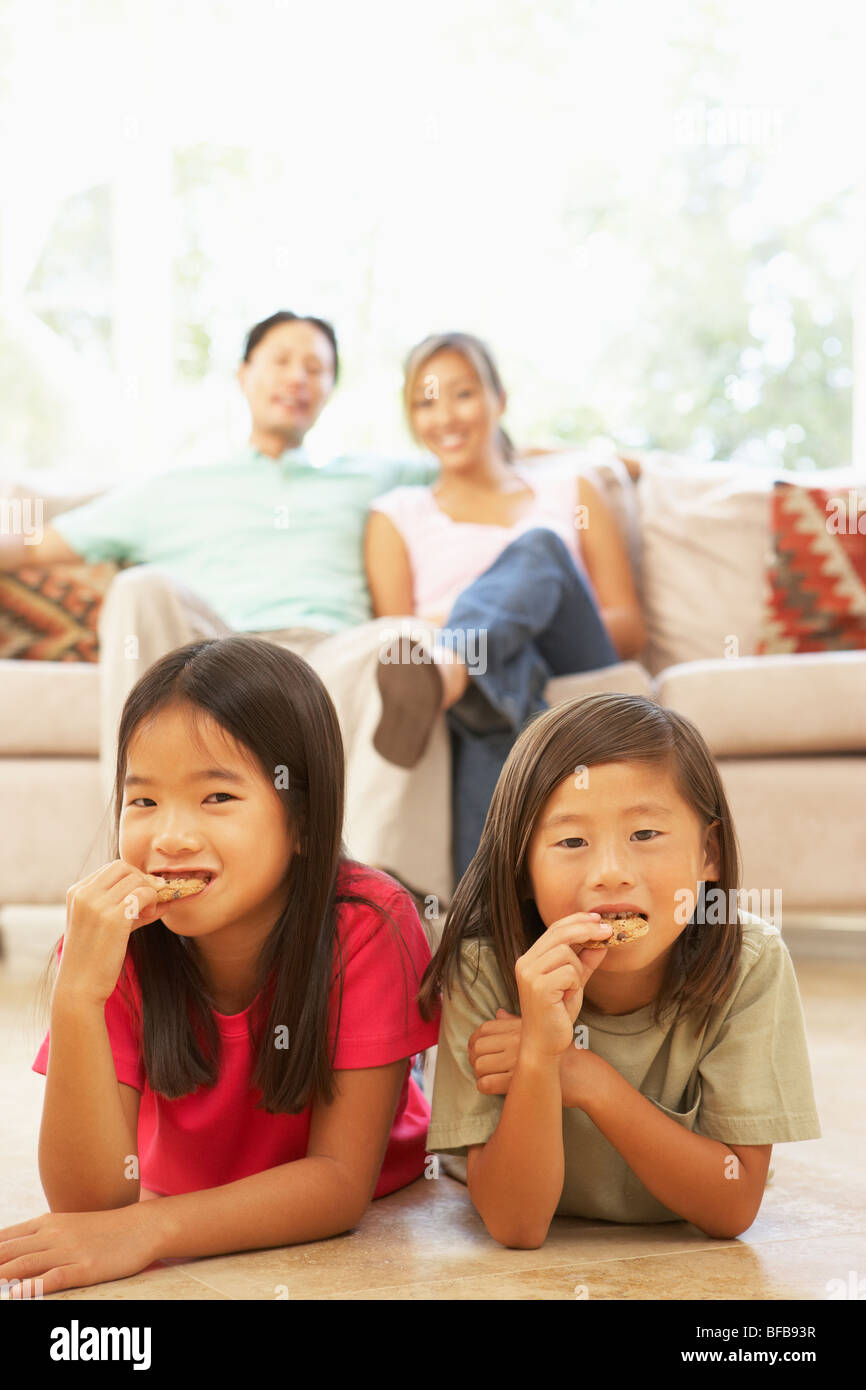 Two Girls Eating Cookies At Home Stock Photo - Alamy