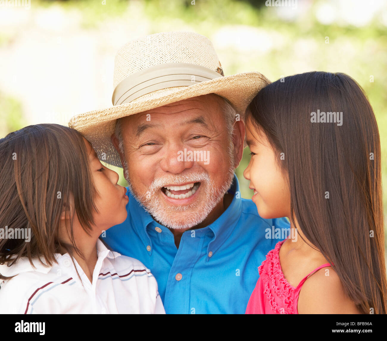 Grandfather With Granddaughters In Garden Stock Photo - Alamy