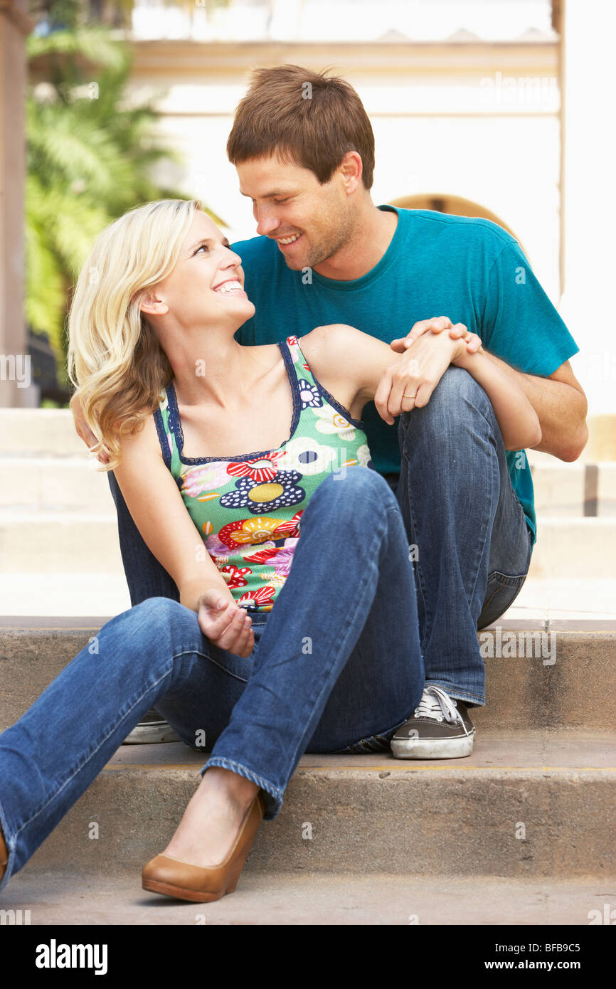 Young Couple Sitting On Steps Of Building Stock Photo - Alamy