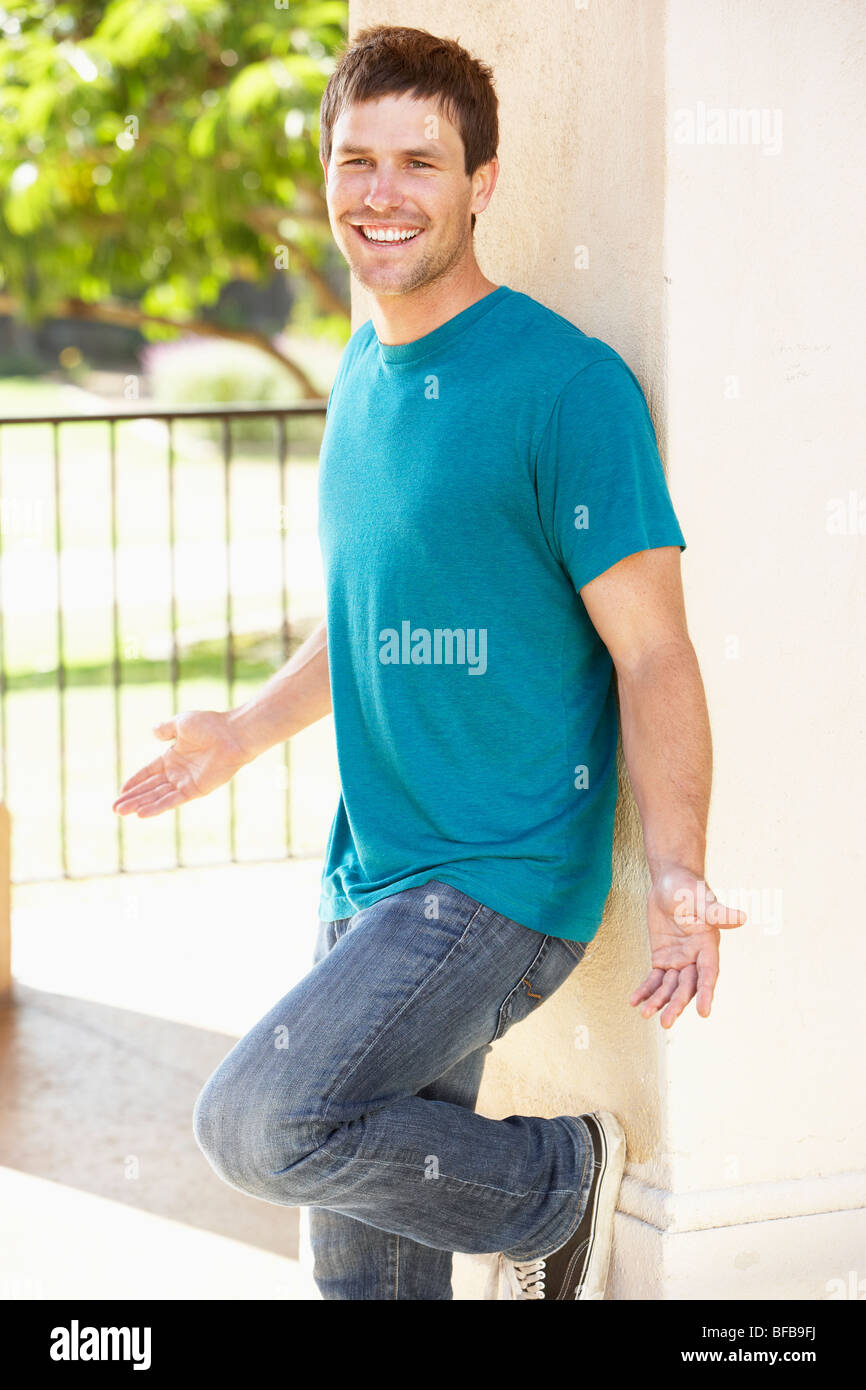 Young Man Leaning Against Pillar Stock Photo - Alamy