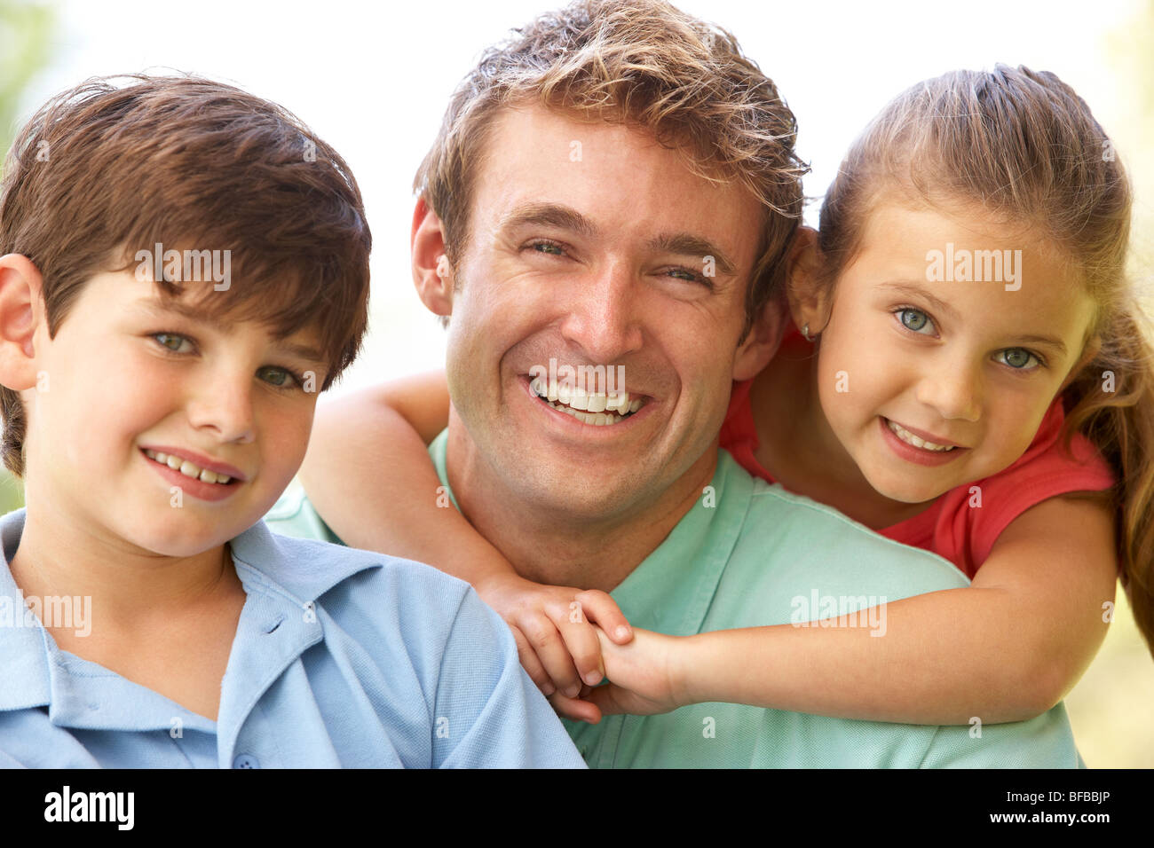 Father With Children In Park Stock Photo - Alamy