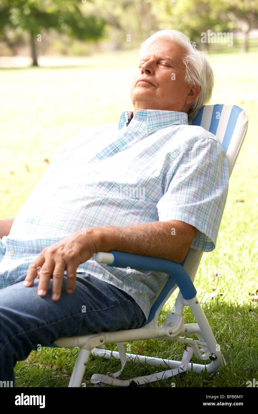 Mature man sleeping in chair hi-res stock photography and images - Alamy