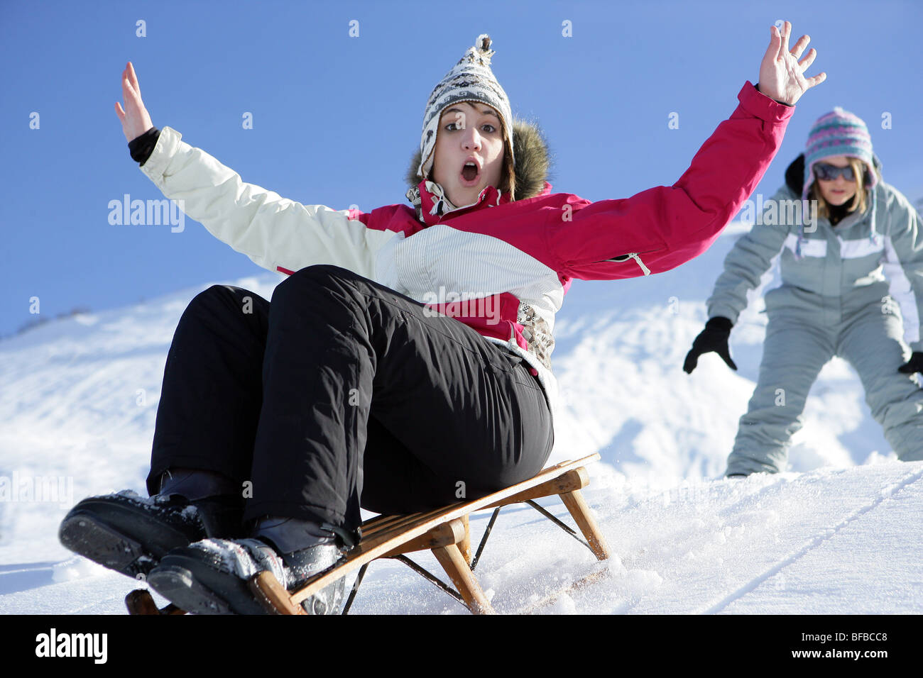 Teenager sliding down a hill on a sled Stock Photo - Alamy