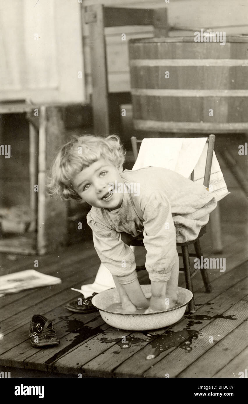 Little Girl Washing Her Feet on Porch Stock Photo - Alamy