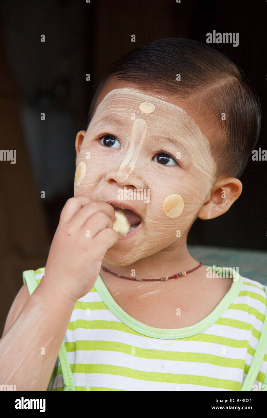 Child with tanaka makeup eating Stock Photo - Alamy