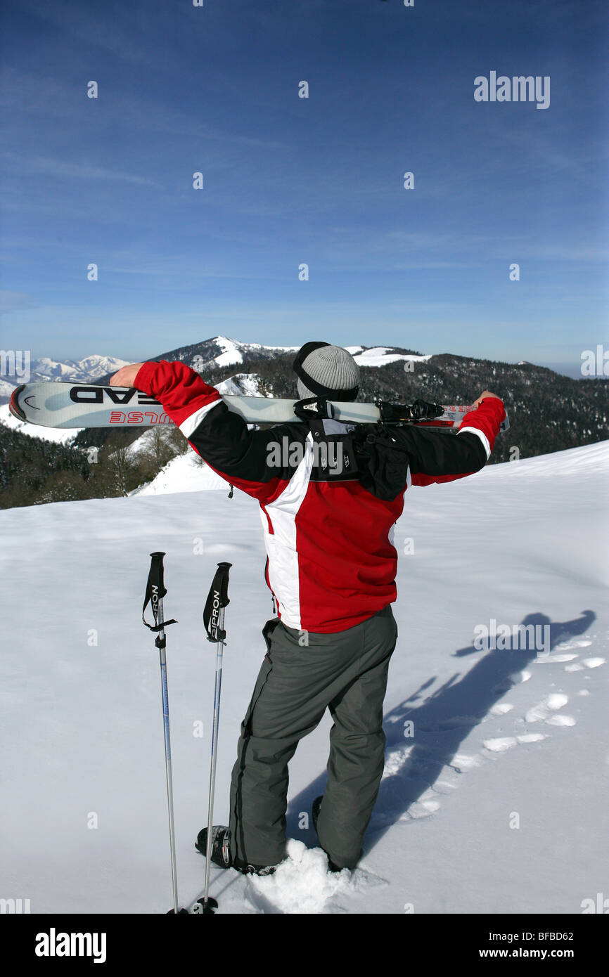 Man with skis on his back Stock Photo - Alamy