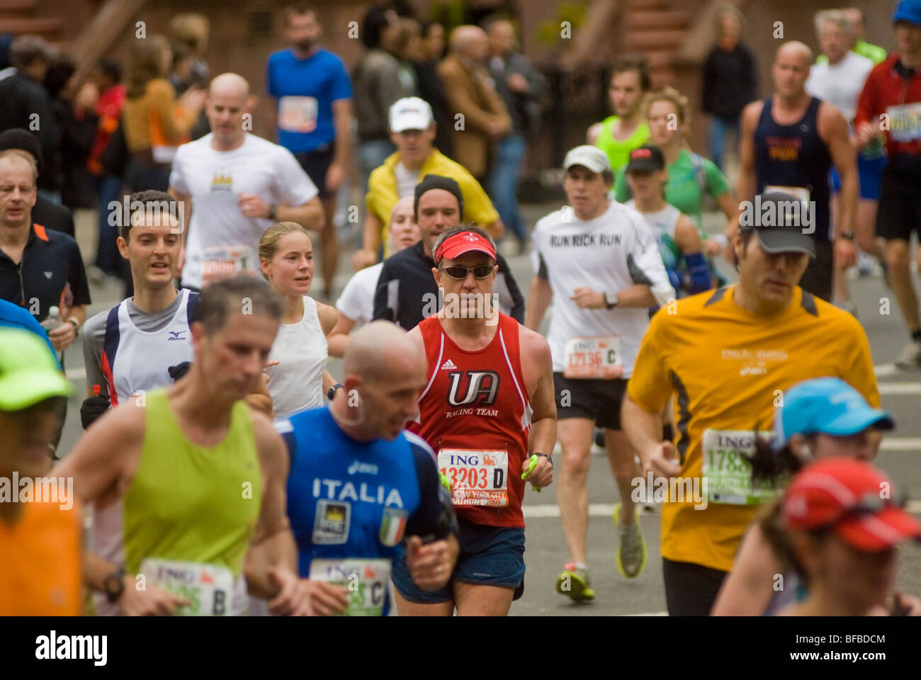 Runners pass through Harlem at the 22 mile marker near Mount Morris ...