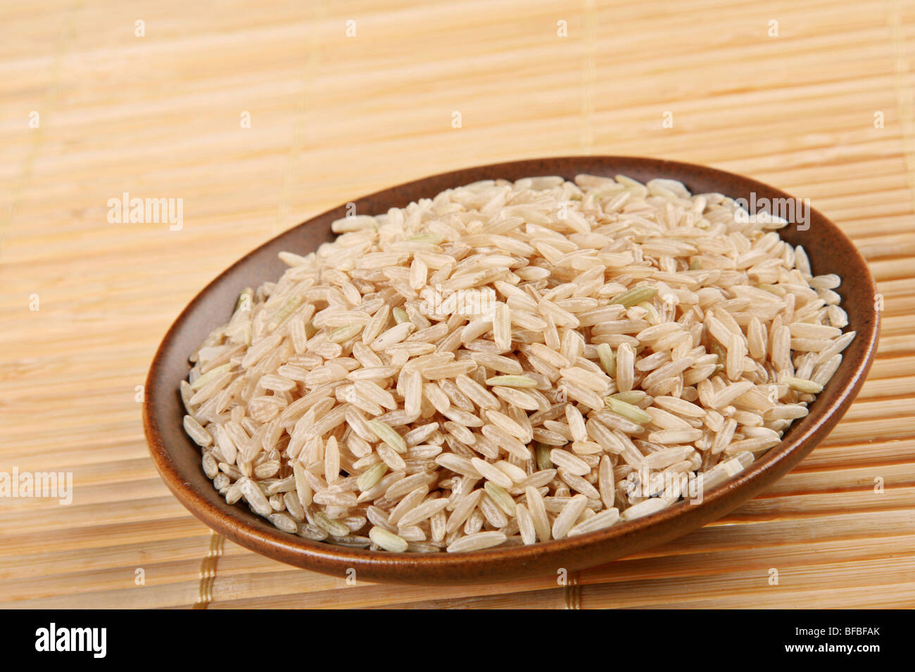 Rice detail view in brown plate Stock Photo - Alamy