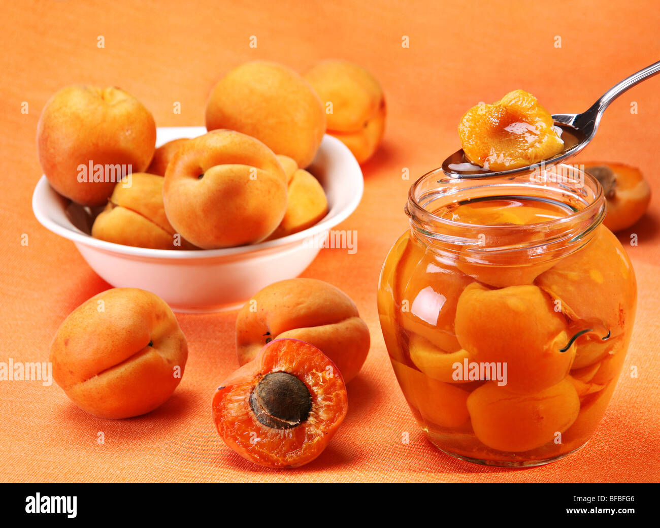 Preserved apricot in spoon with fresh fruit Stock Photo - Alamy