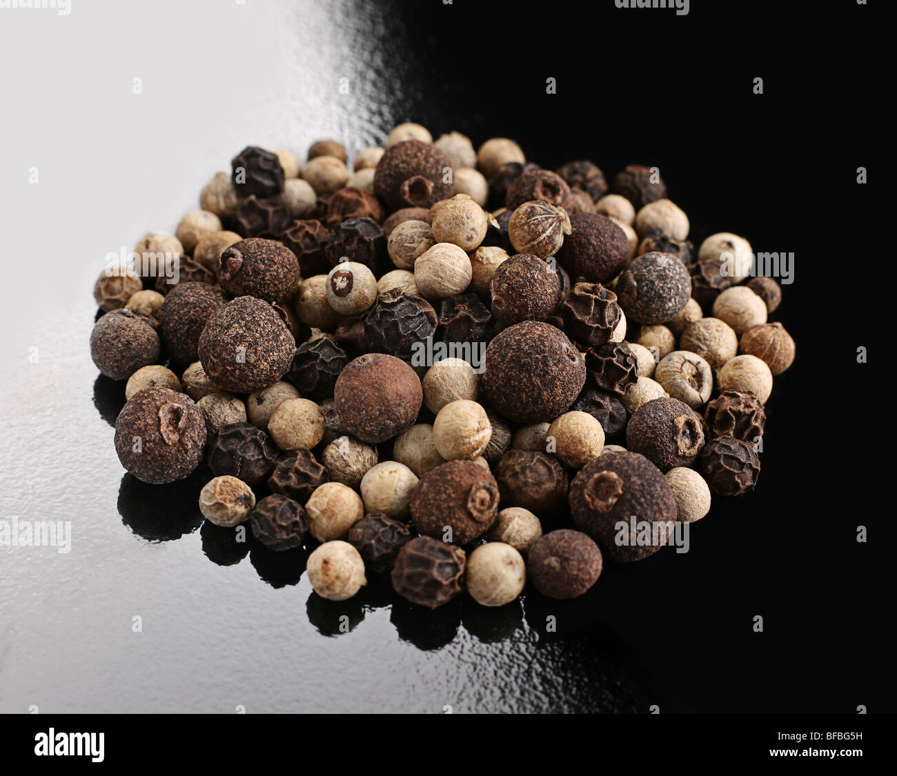 Peper mix spice round heap closeup on black white background Stock ...