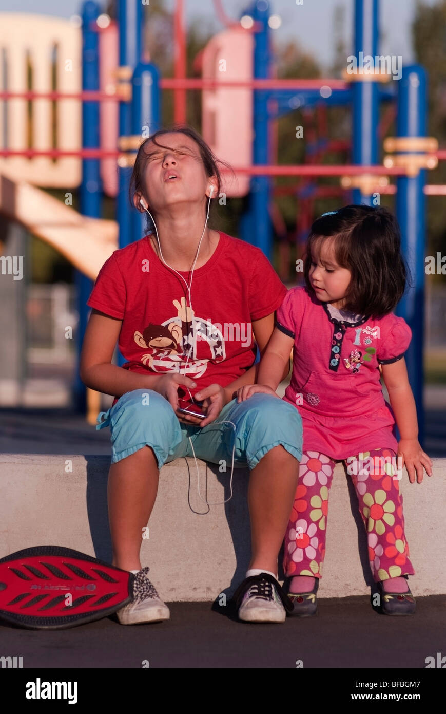 11 Year Old Girl Listens To An Ipod Next To Her 2 Year Old Sister In
