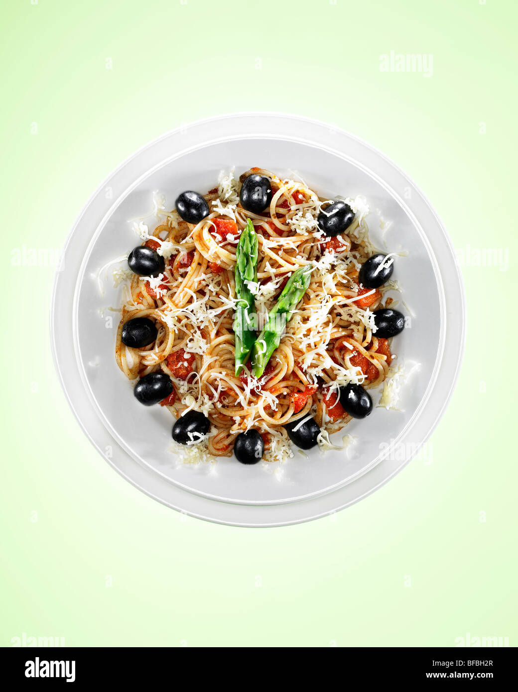 Spaghetti with black olives and asparagus indicating lunch time of one ...