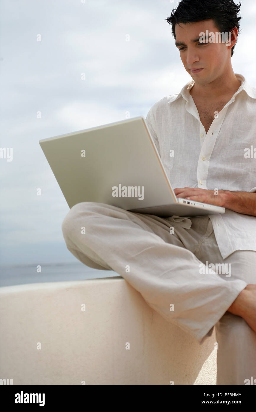 Man with laptop on a terrace Stock Photo - Alamy