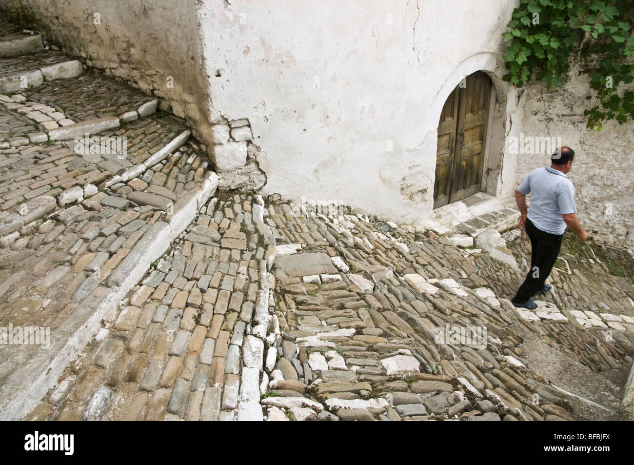 A typical narrow cobbled alleyway in the Mangalemi district of Berat in ...