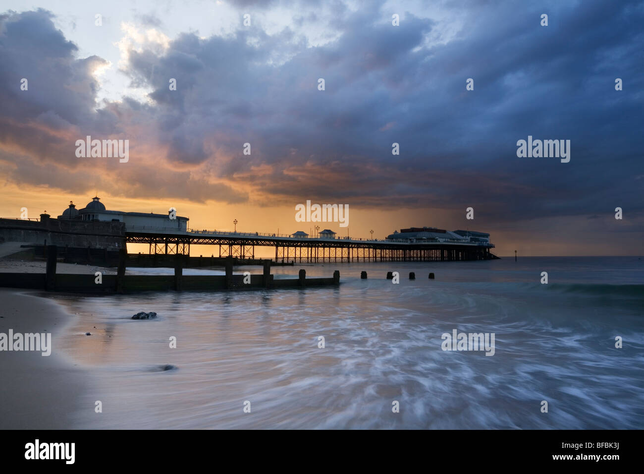 Cromer Pier with summer storm clouds around sunset Stock Photo - Alamy