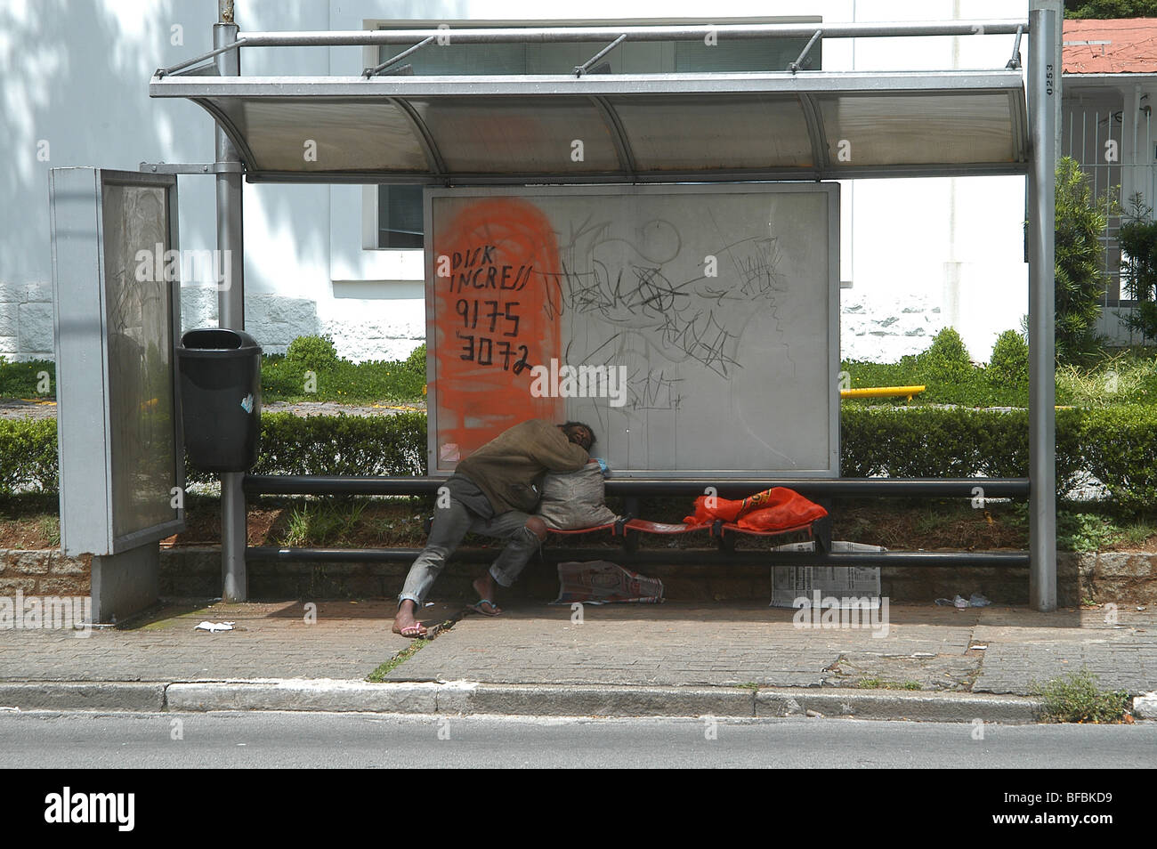 A poor and walker at bus stop in São Paulo, Brazil. 23/10/2009 at 11 ...