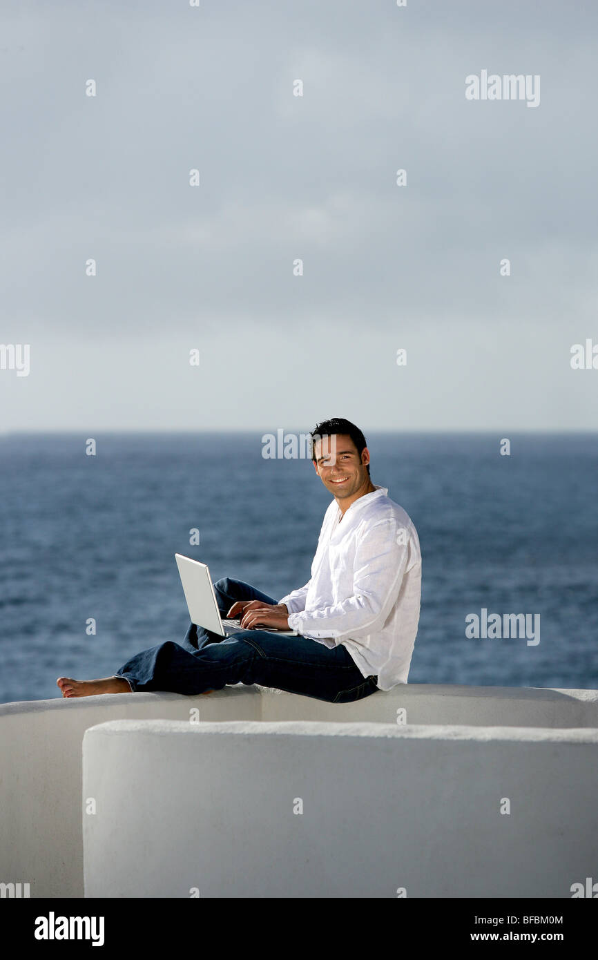 Man with laptop computer on a terrace Stock Photo - Alamy
