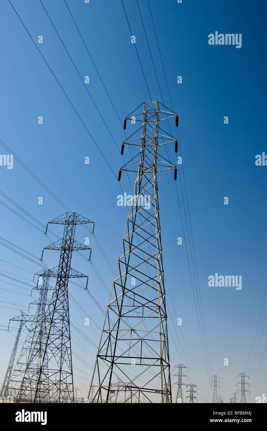 Transmission towers in a row Stock Photo - Alamy