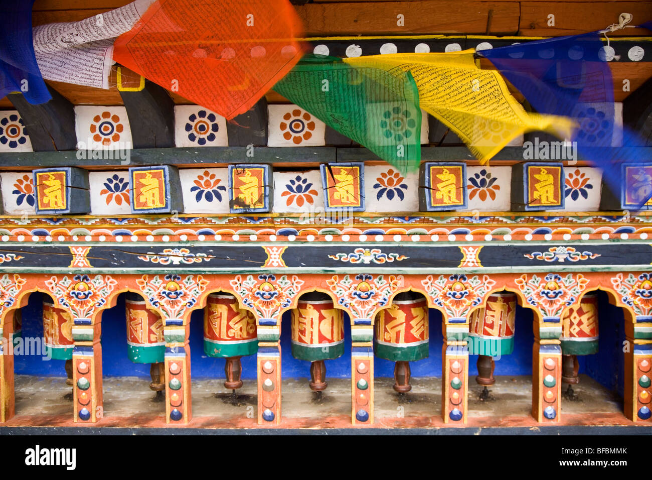 Prayer wheels and flags are colorful elements of a small Buddhist ...