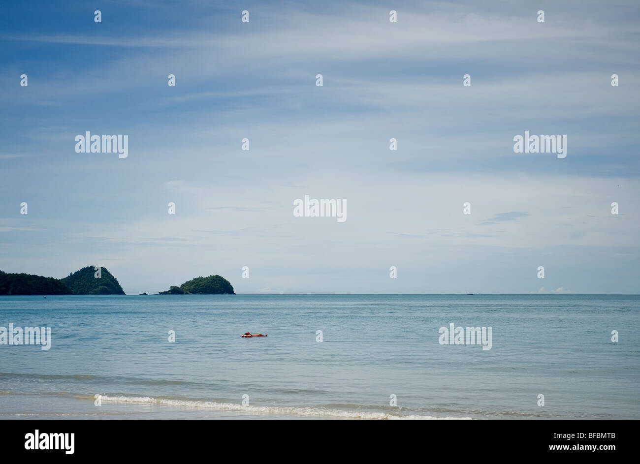 Tourist floating on an inflatable sunbed off Pantai Tengah beach in ...