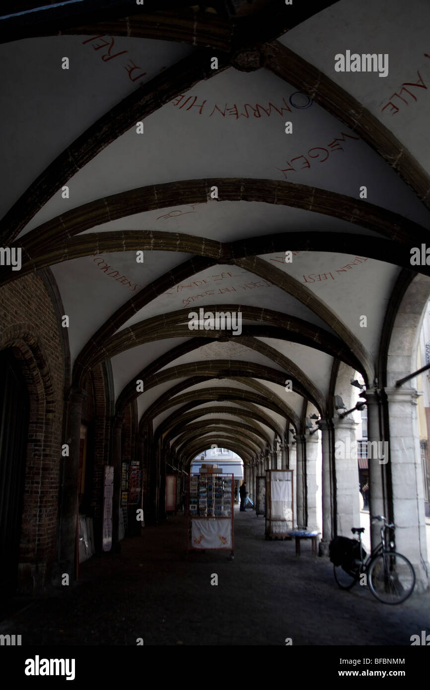 Gothic arches with postcards stall, Bruges Belgium Stock Photo - Alamy