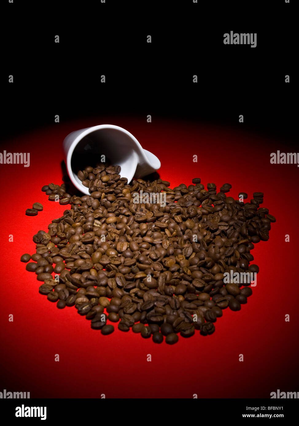 A fallen cup with coffee beans spread out Stock Photo - Alamy