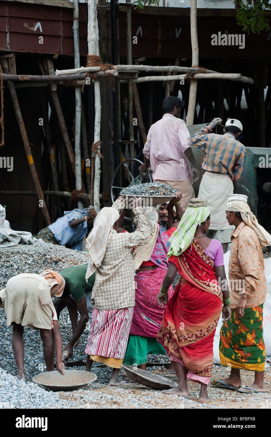 Indian women working on a building site, carrying sand and stone on ...