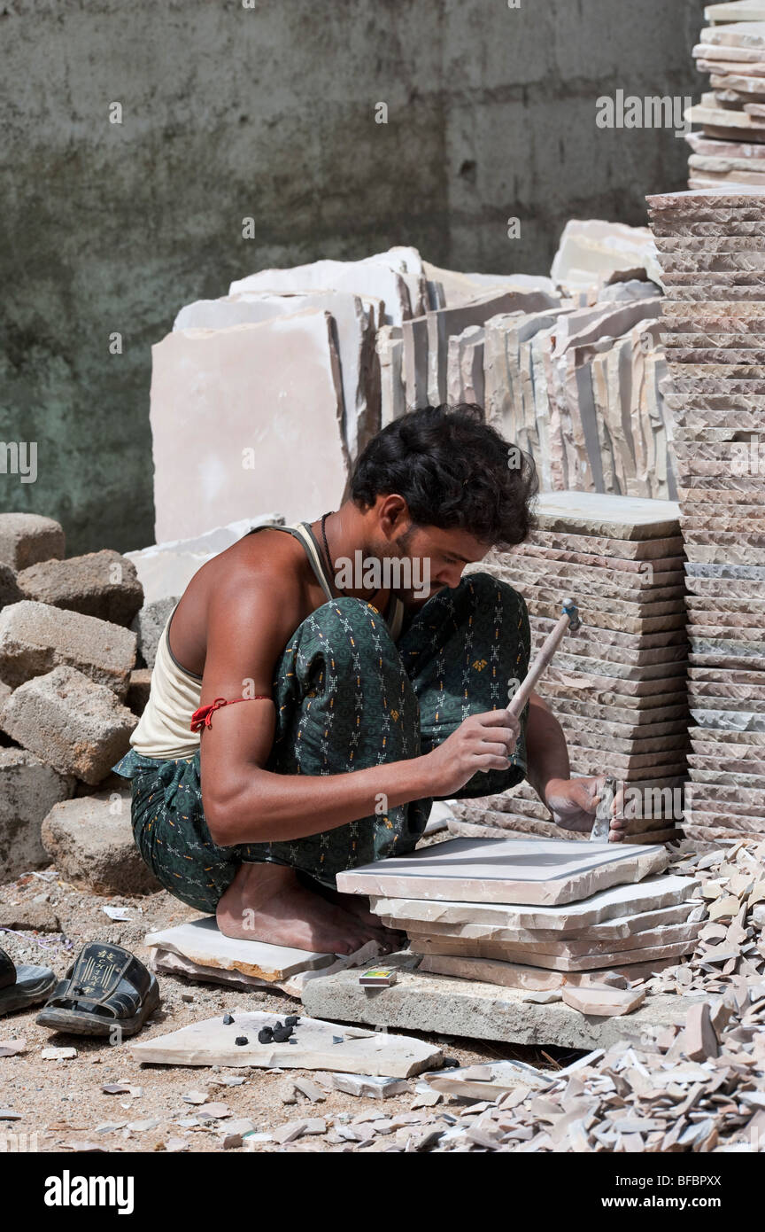 Indian craftsman making marble floor tiles by hand in a street ...