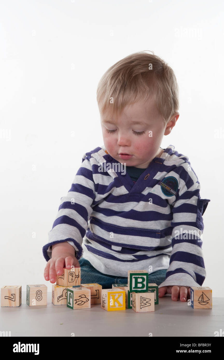 little boy playing with blocks white background Stock Photo - Alamy