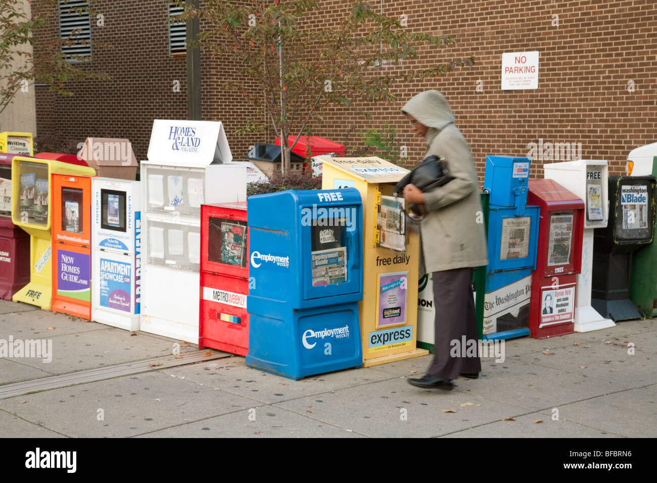 A commuter picks up a daily newspaper in the Friendship Heights area ...