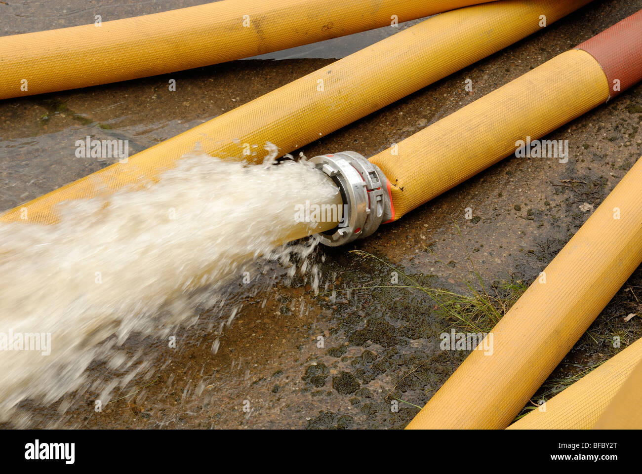 Fire & Rescue Service High Volume pumps and hose used to release flood ...