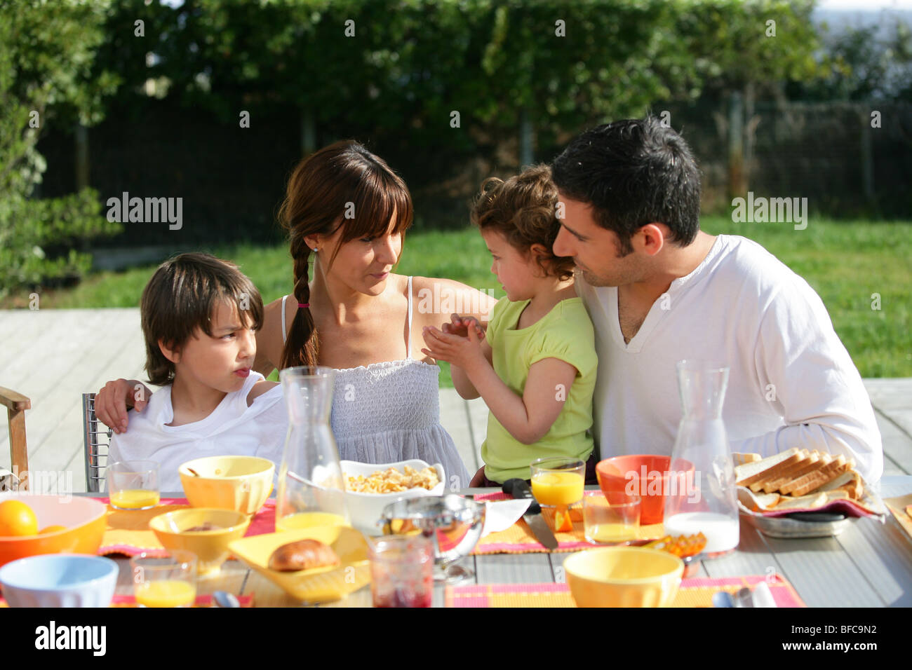 Family having brunch outside on a sunny day Stock Photo - Alamy