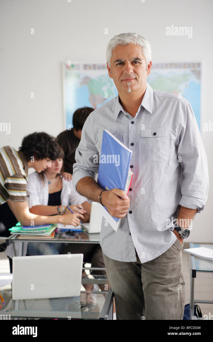 Male teacher in classroom with pupils Stock Photo - Alamy