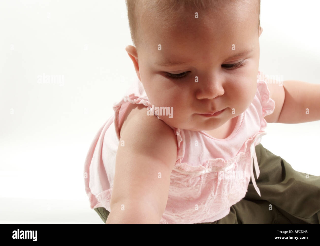 12 month old baby girl playing on floor in pink Stock Photo - Alamy