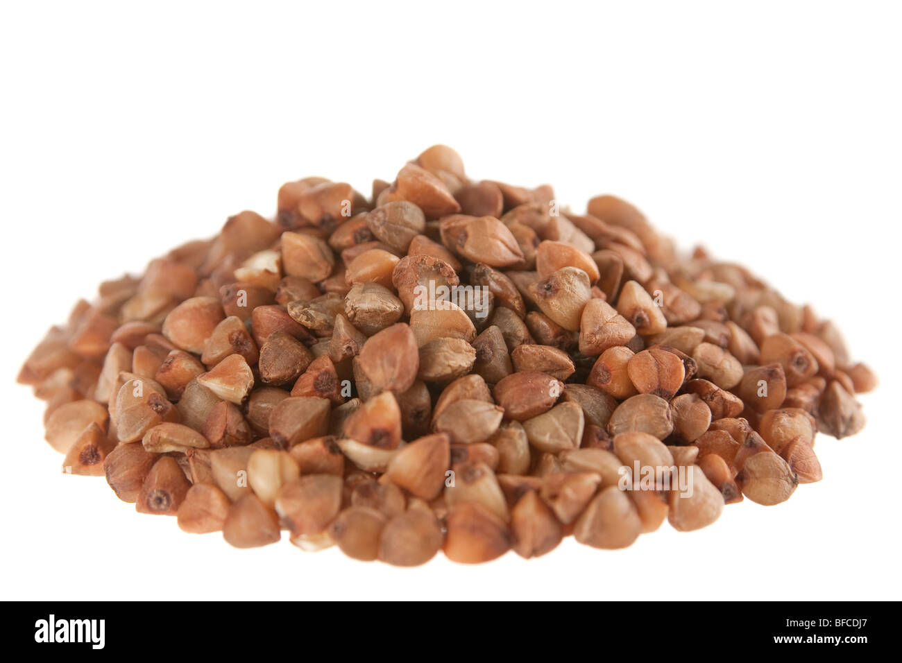 Dry buckwheat heap closeup on white background Stock Photo - Alamy