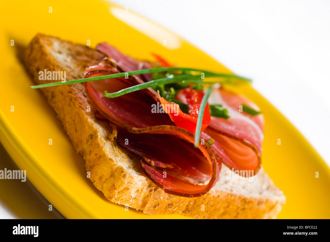 whole wheat toast on a yellow plate Stock Photo - Alamy