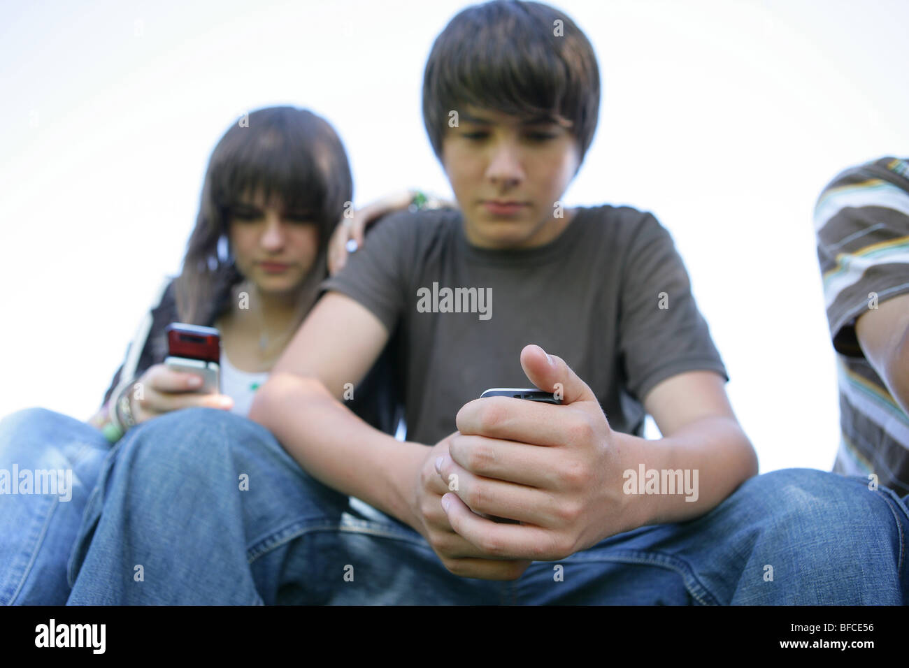 Teenagers texting from mobile telephones Stock Photo - Alamy