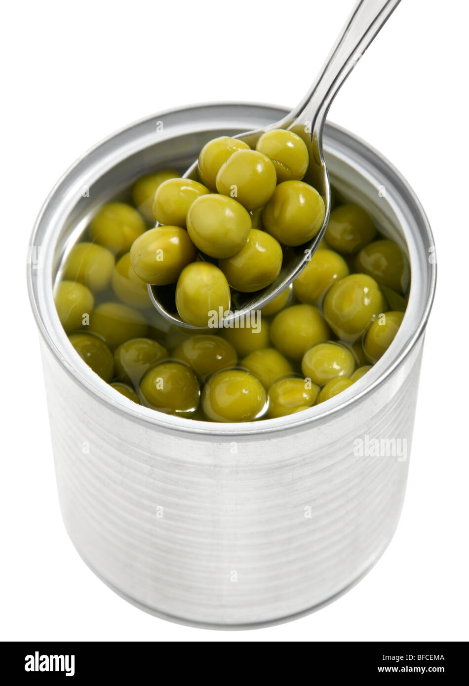 Preserved peas vegetable in metal spoon closeup Stock Photo - Alamy