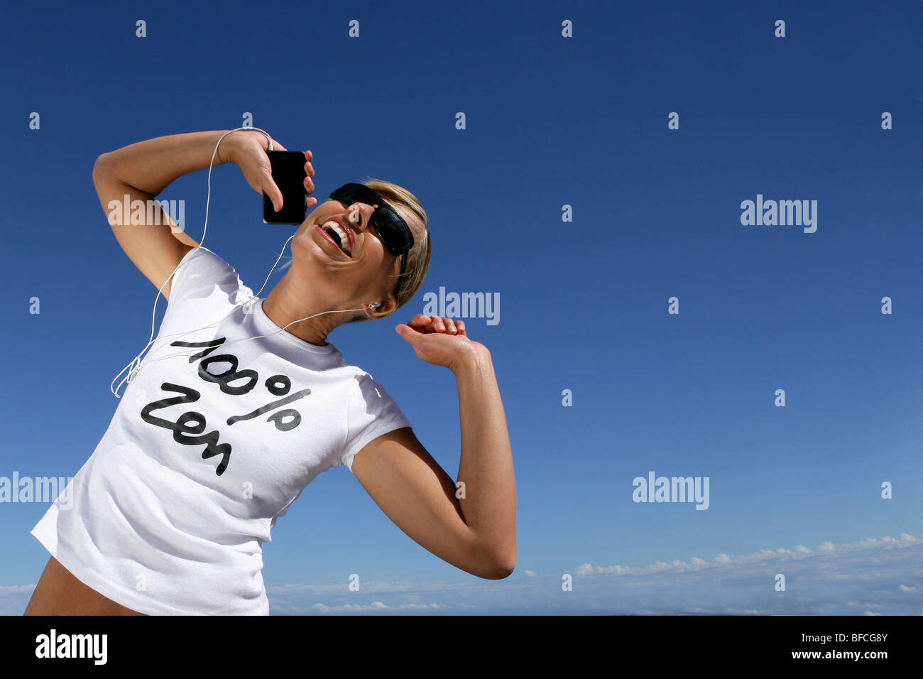 Woman dancing while listening to her mp3 player Stock Photo - Alamy