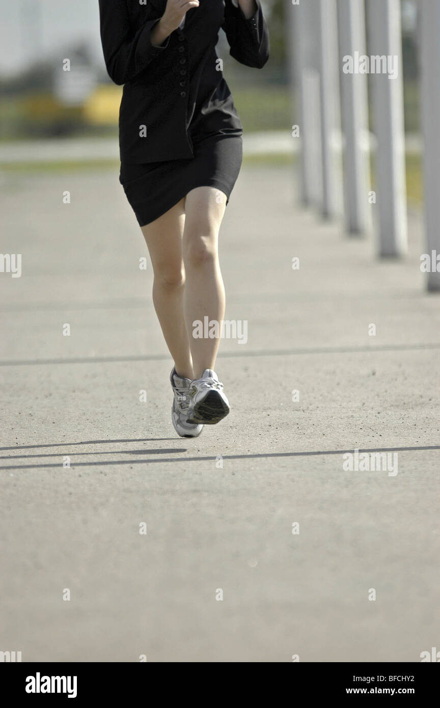 Business woman running Stock Photo - Alamy