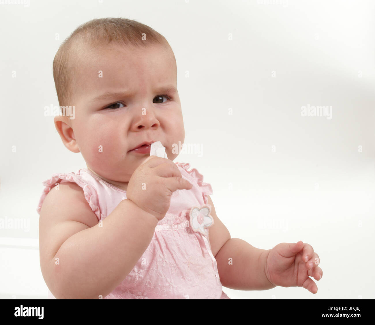 12 month old baby girl playing on floor in pink Stock Photo - Alamy