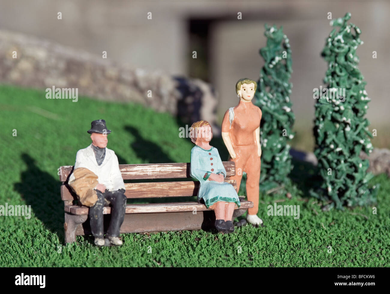 miniature models sitting on bench Stock Photo - Alamy