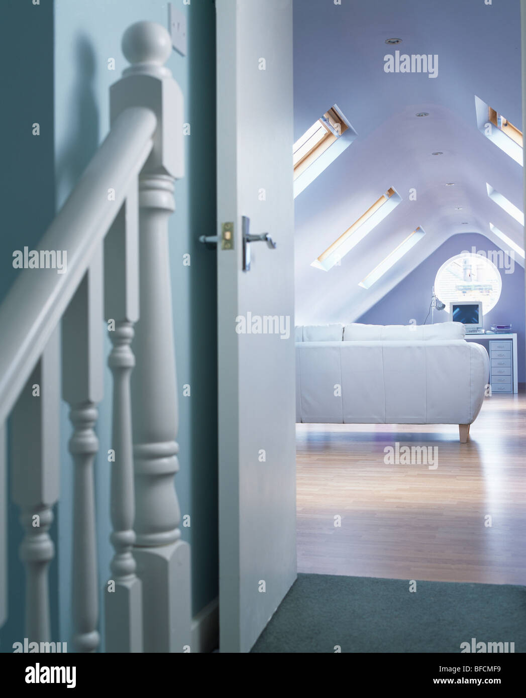 Door open to mauve living room in loft conversion Stock Photo - Alamy