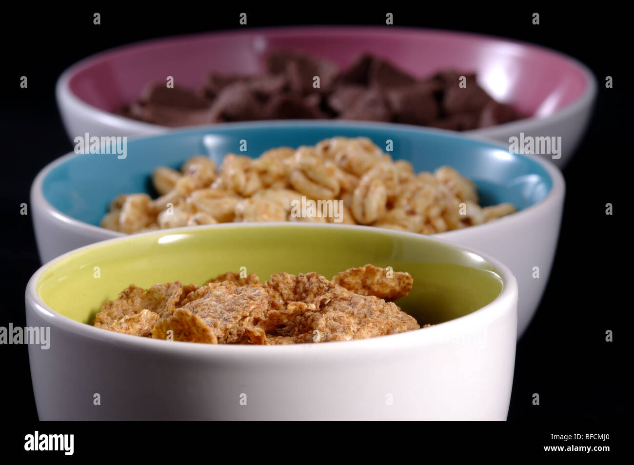 Three colorful bowls with breakfast cereals Stock Photo - Alamy
