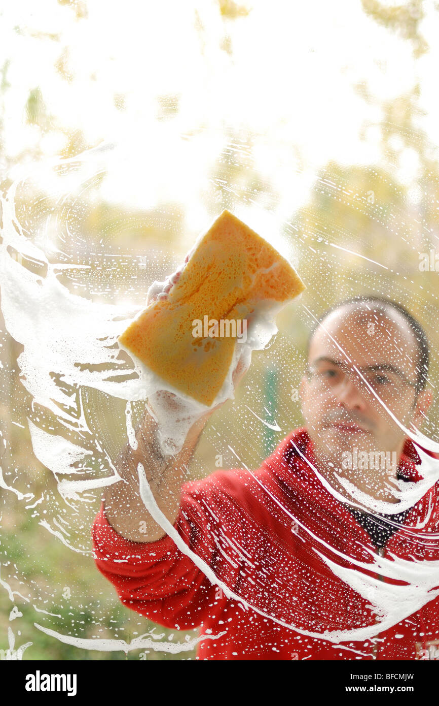 Man washing window with a sponge Stock Photo - Alamy